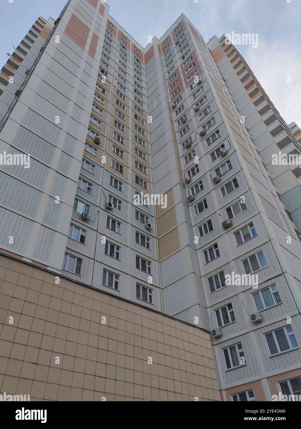 A large multi-story residential building with a pastel color palette of ...