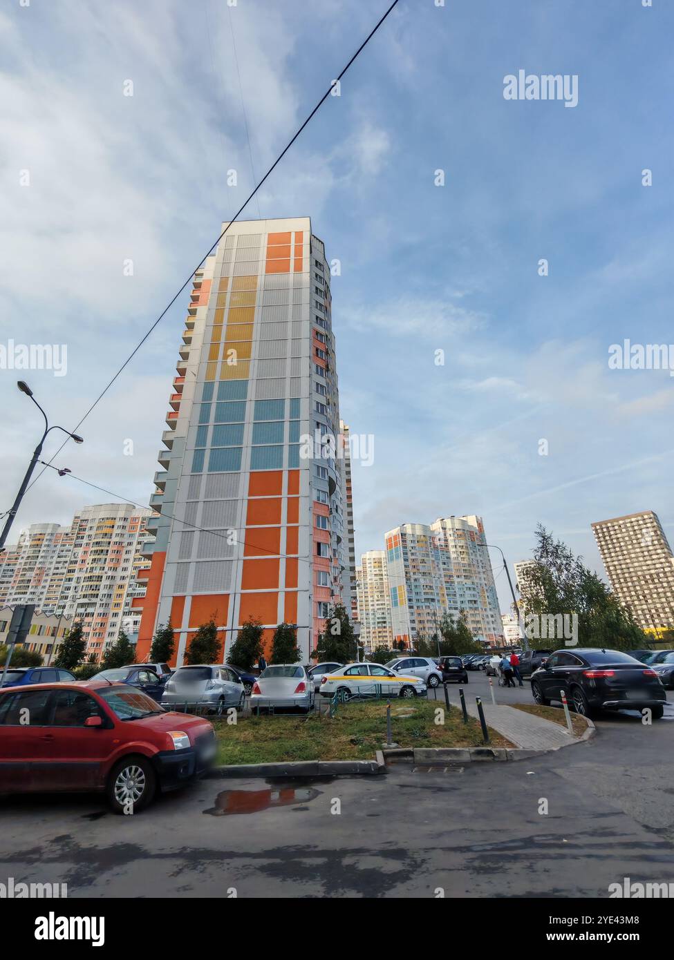 A large multi-story residential building with a pastel color palette of ...