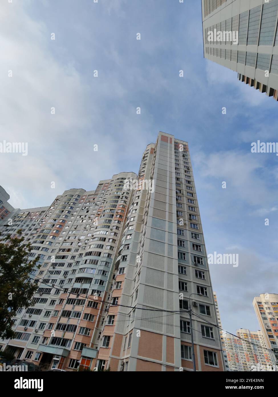 A tall apartment building with pastel-colored balconies and windows ...