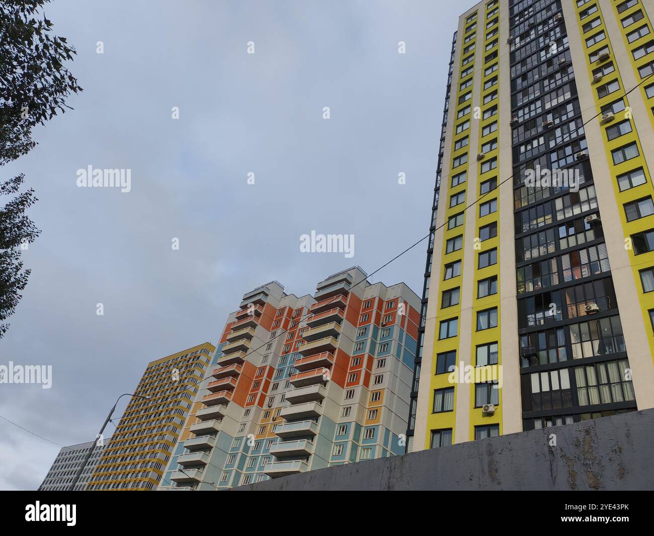 A towering residential building with pastel accents, featuring a wide ...