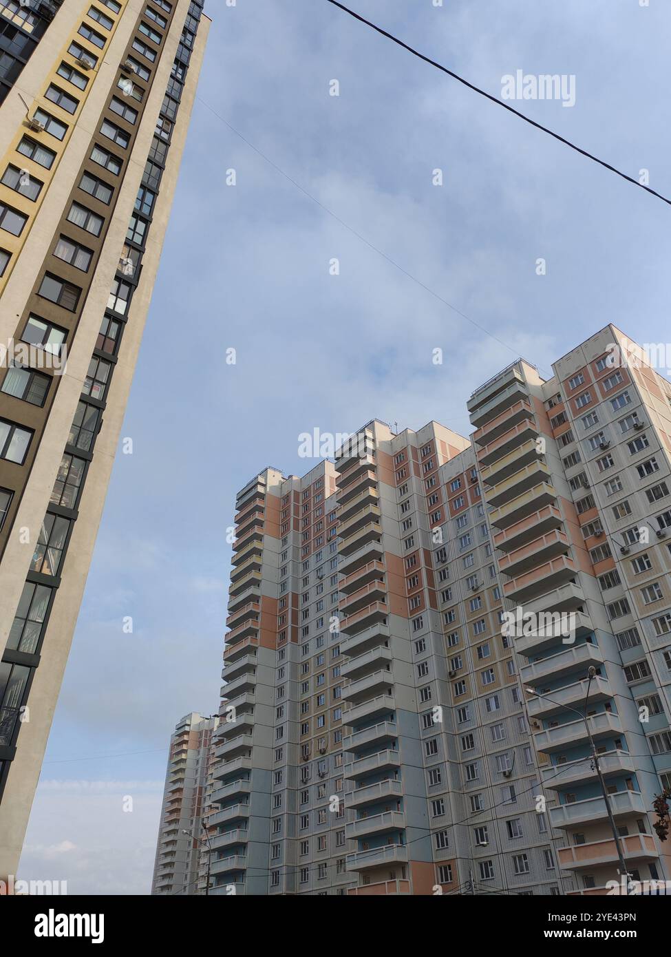 A towering residential building with pastel accents, featuring a wide ...