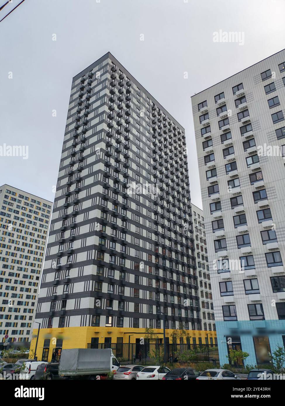 A pastel-colored high-rise residential building with curved balconies ...