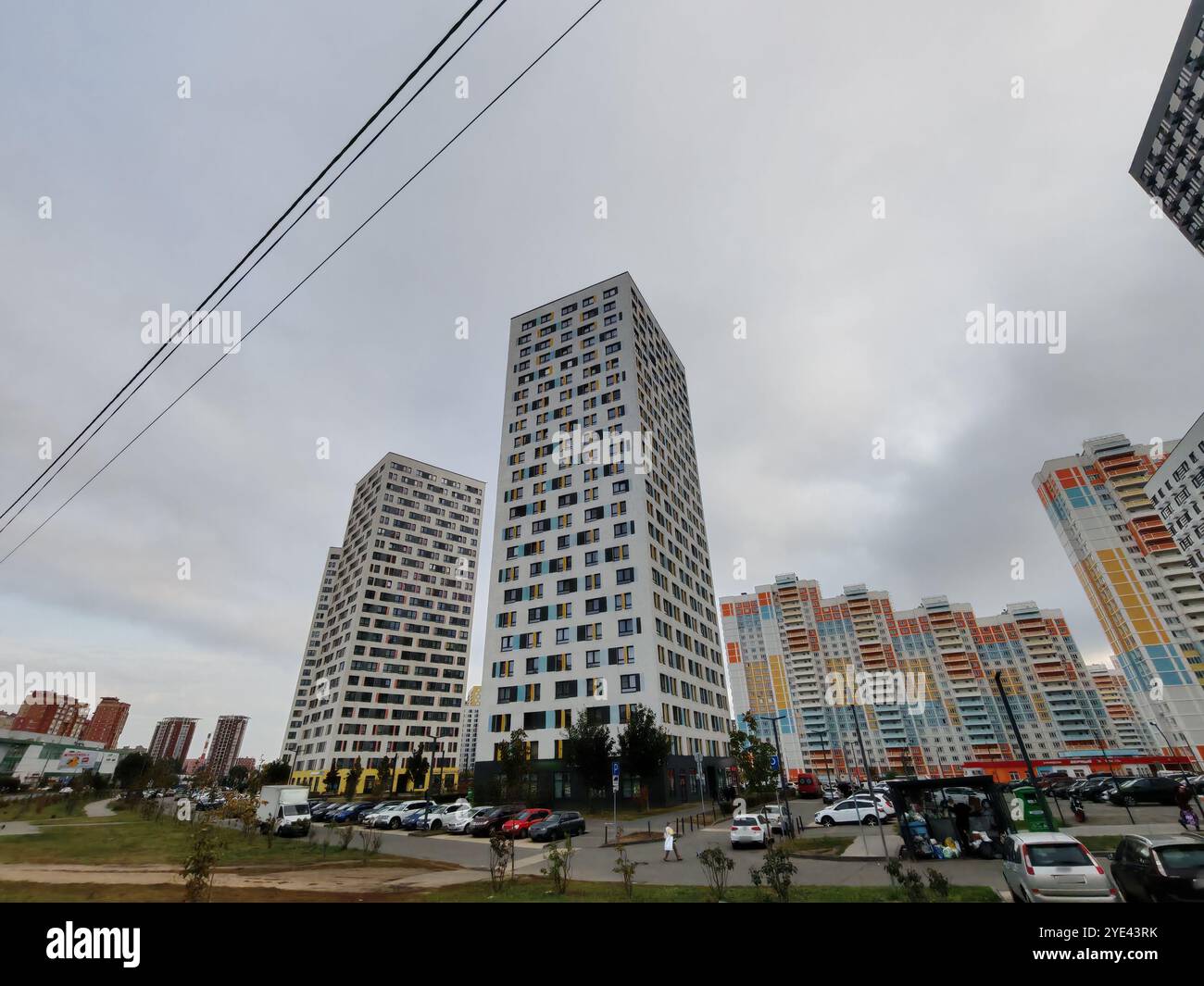 A pastel-colored high-rise residential building with curved balconies ...