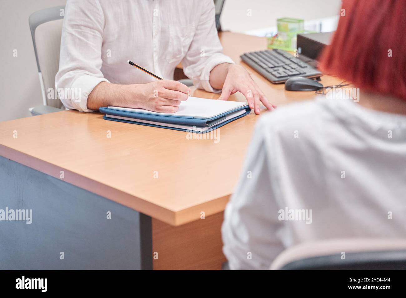 doctor treating a woman in the office. receptionist treating a red ...