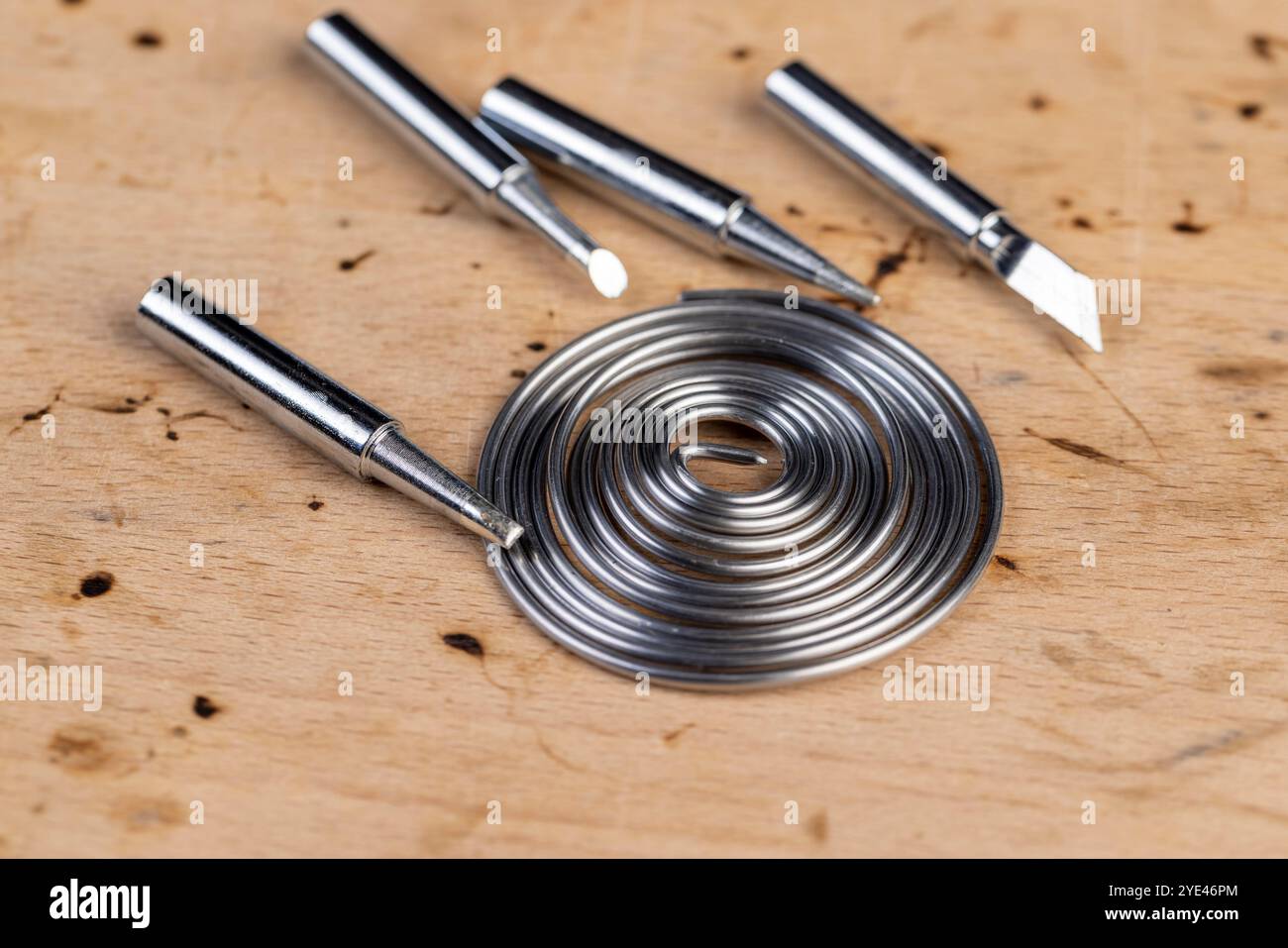 thin and soft solder and soldering iron tips, twisted as a spring ...
