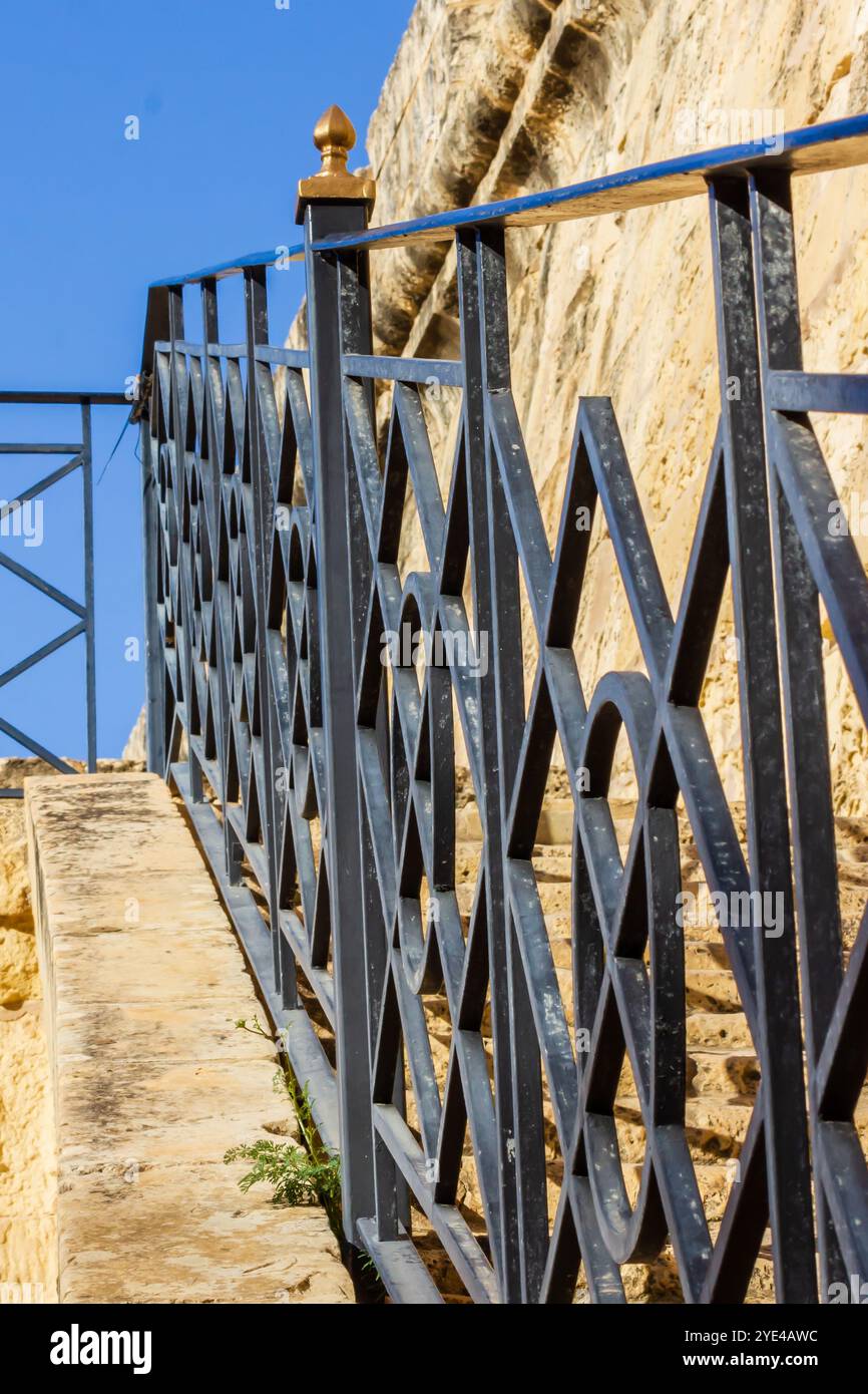 Rustic Stone Staircase with Ornate Metal Railings Stock Photo - Alamy
