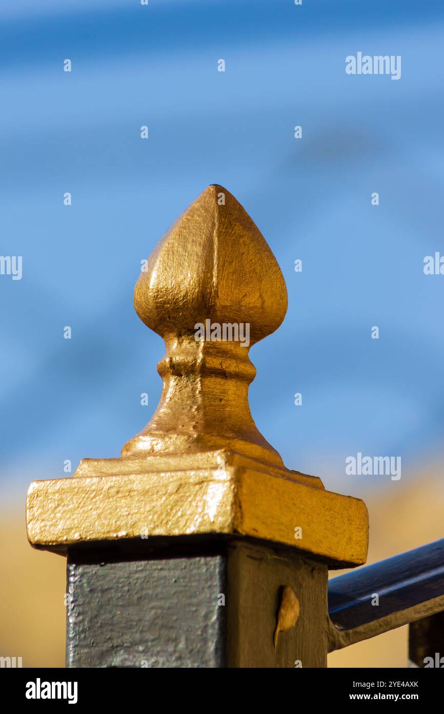 Elegant Gold Fence Post Against Clear Blue Sky Stock Photo - Alamy