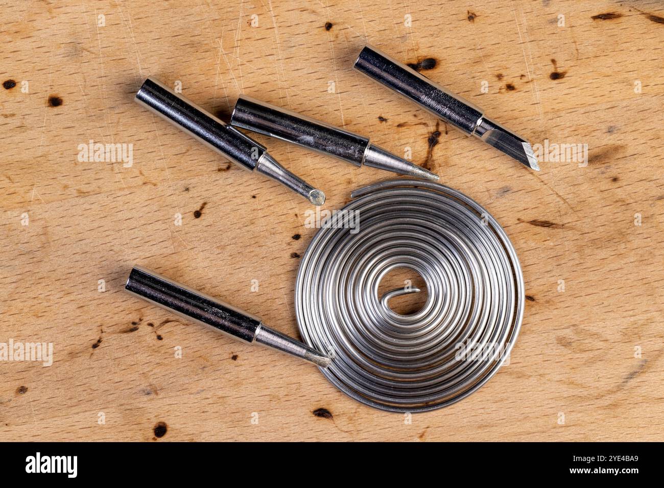 solder and soldering iron tips closeup, twisted solder for repair work ...