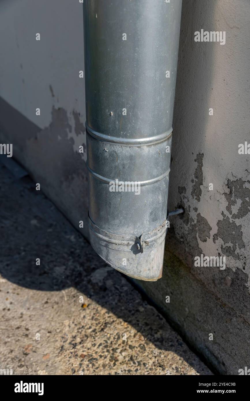wide metal pipes for water drainage, part of a system of downspout ...