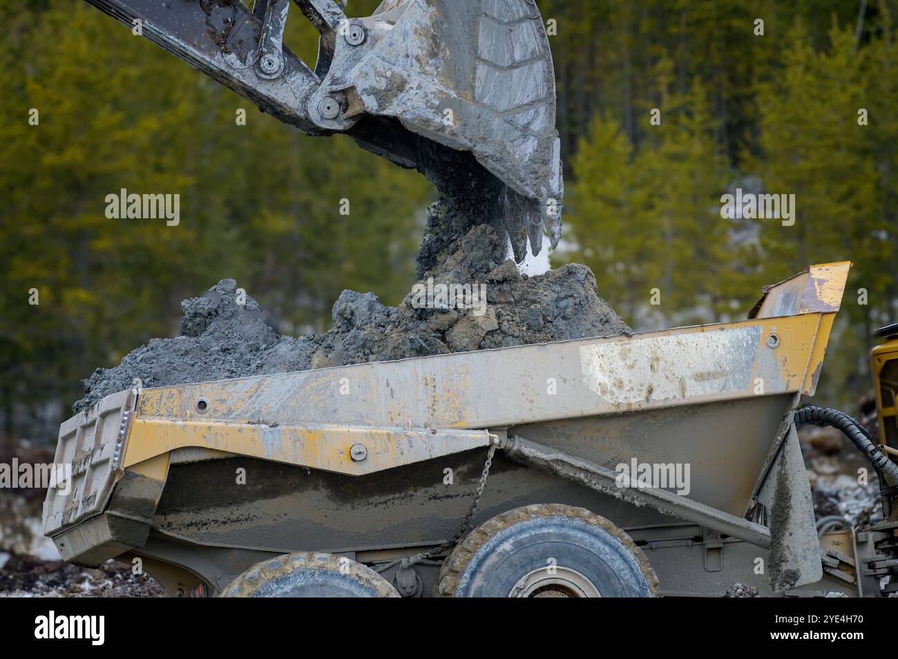 Bucket loading a dumper with soil on a northern construction site Stock ...