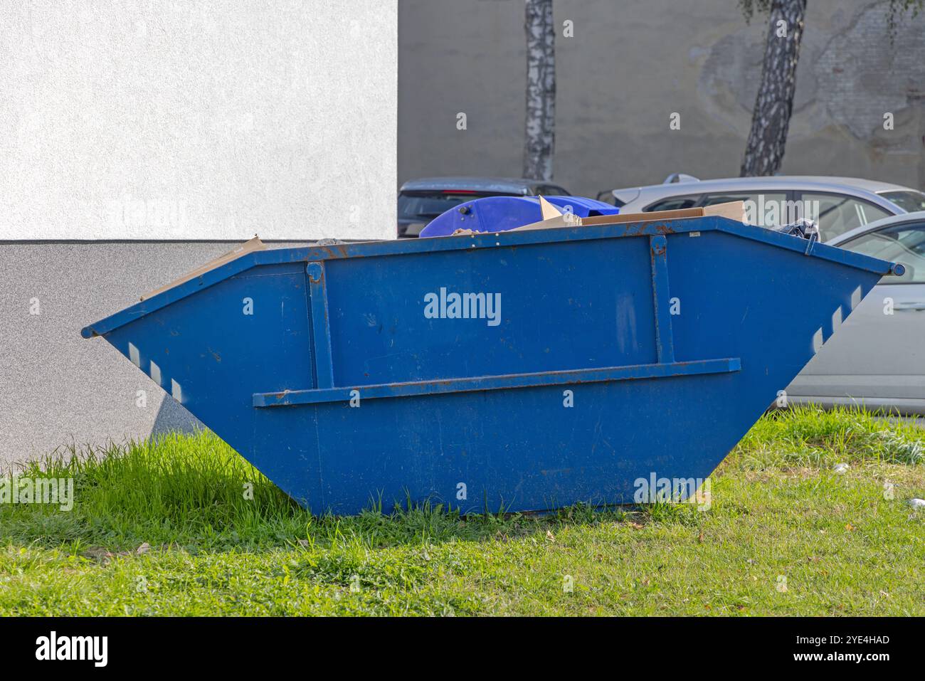 Blue Skip Waste Debris Open Top Metal Container at Green Lawn Grass ...