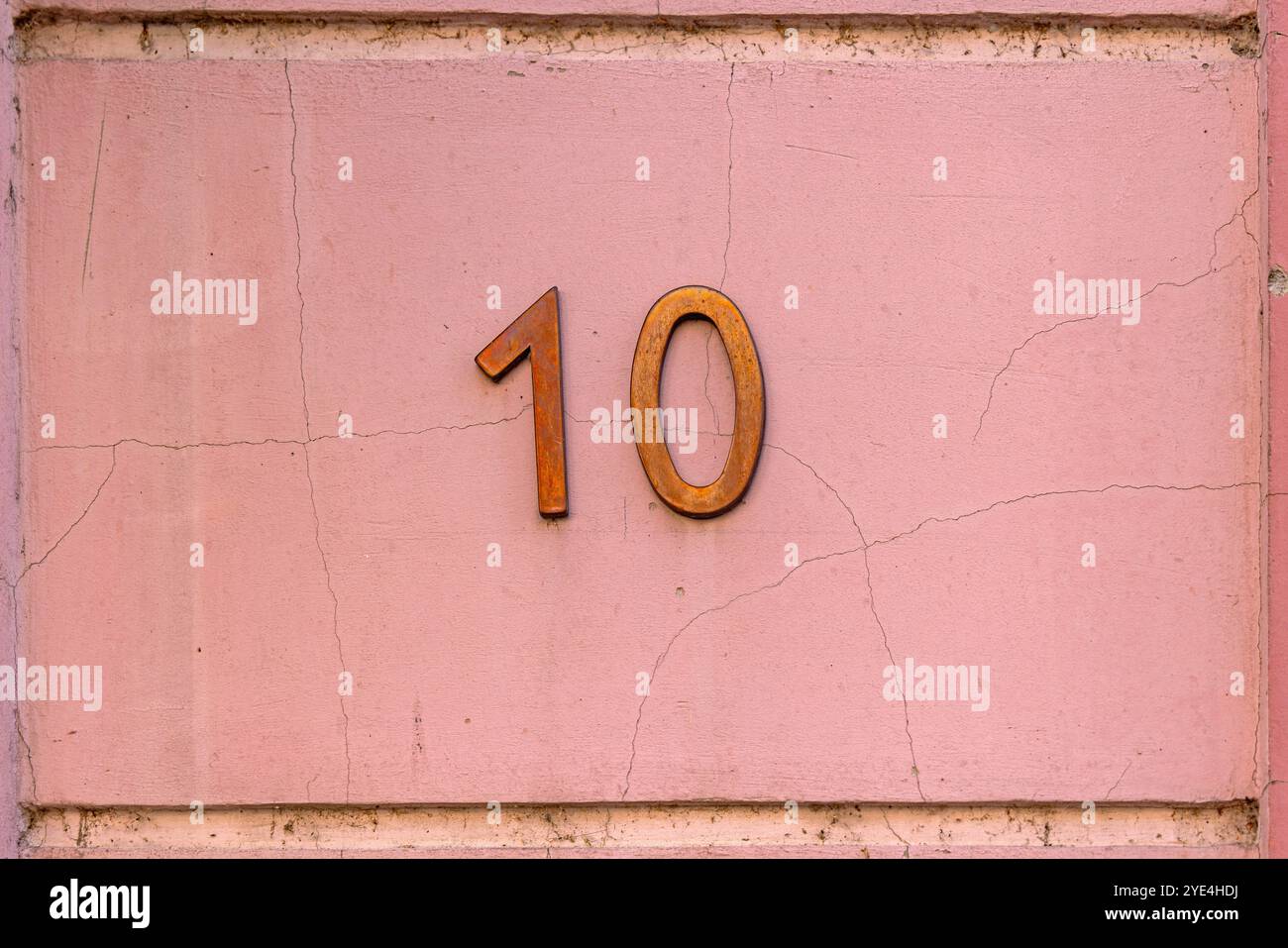 3d Bronze Number Ten Sign at Old Pink House Building Stock Photo - Alamy