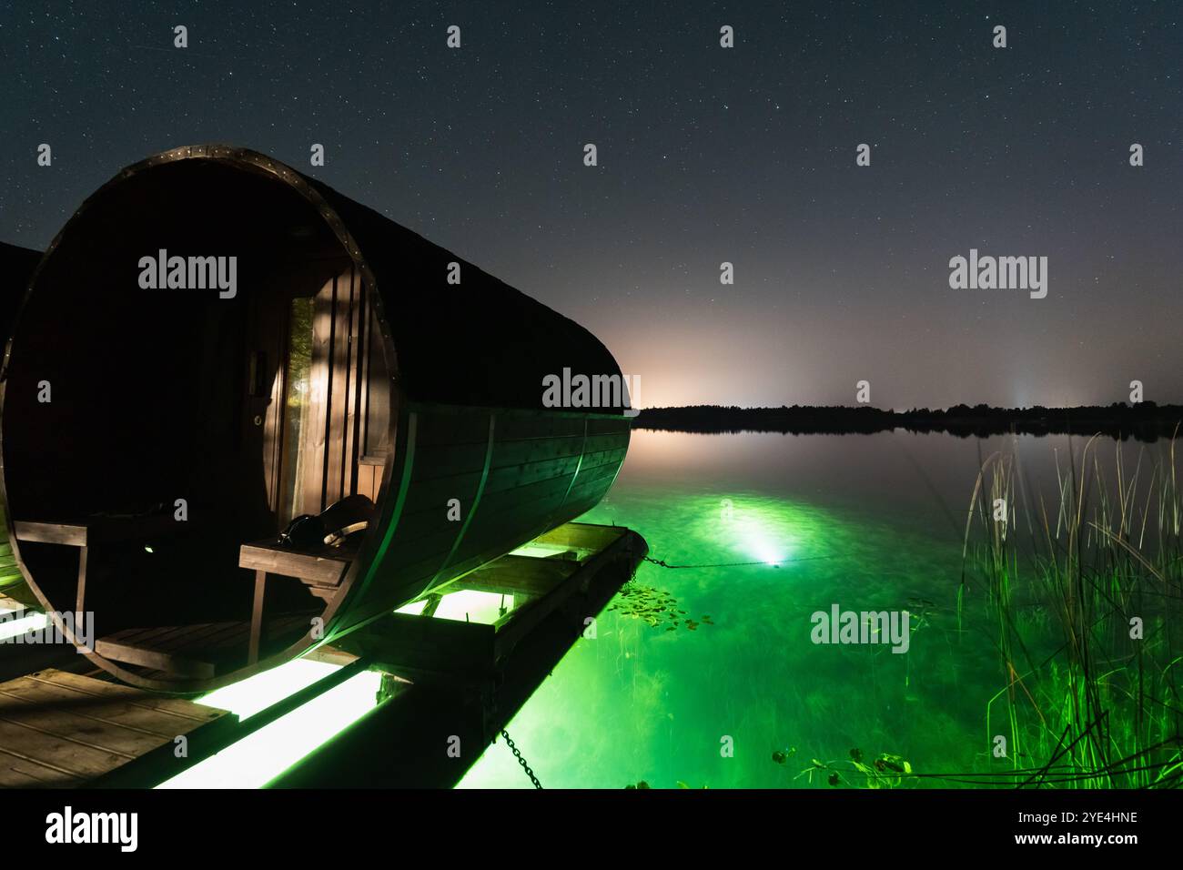 Night photography, clear starry sky, barrel of a house on the water on ...