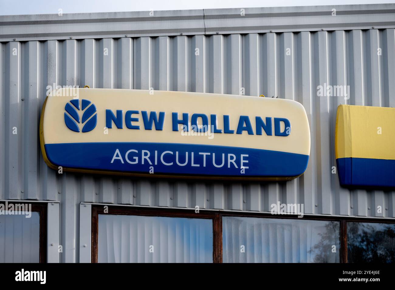 New Holland sign on an agricultural merchants, Warwick, UK Stock Photo ...