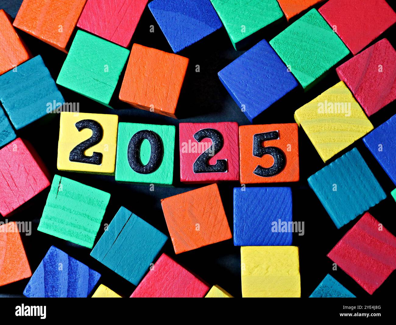 Colored wood blocks with the year 2025 on some of them on blue ...