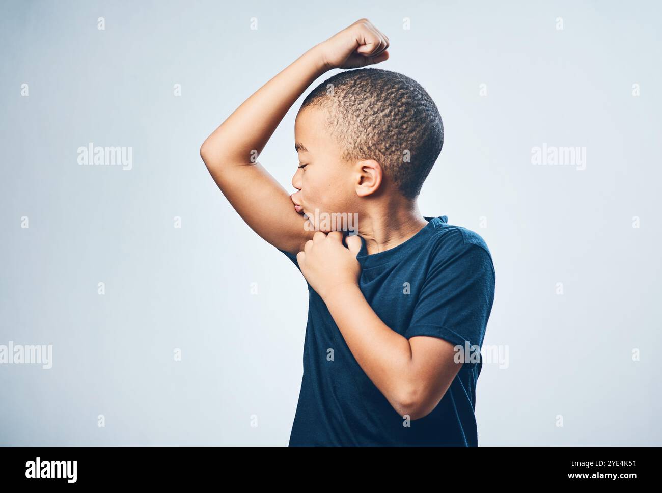Black child, kiss and bicep muscle in studio for fitness success ...