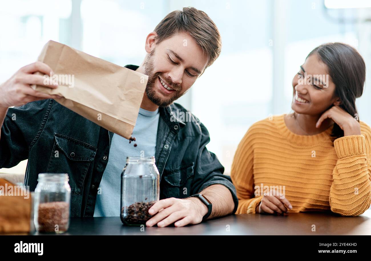 Coffee, jar and sorting with interracial couple in kitchen of home ...