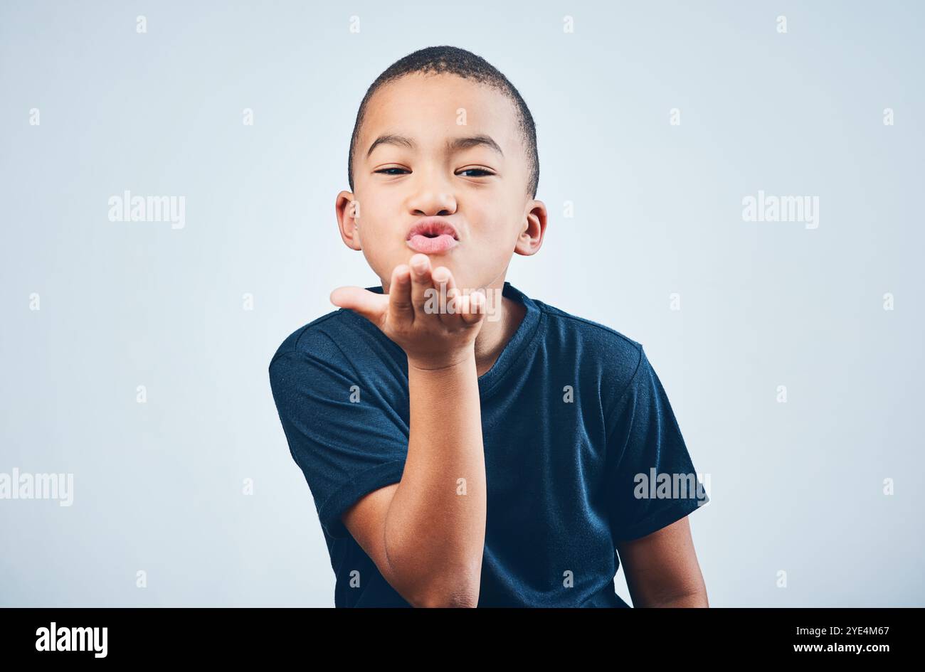 Portrait, blowing kiss and boy with kid, flirty and facial expression ...