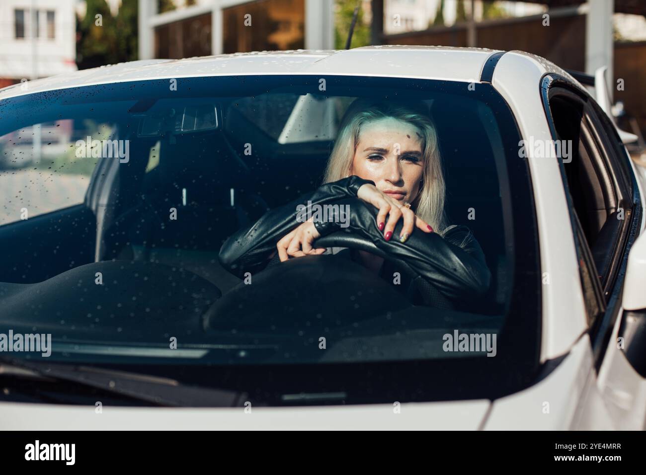 Female driver driving a white car on the road Stock Photo - Alamy