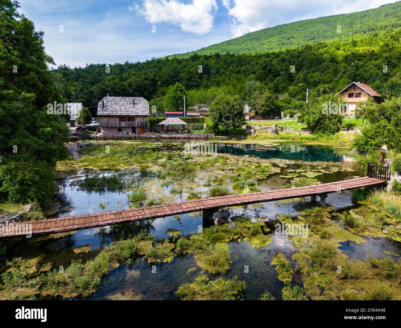 Aerial image of Wonderful Majerovo Vrilo wooden houses and Gacka river ...