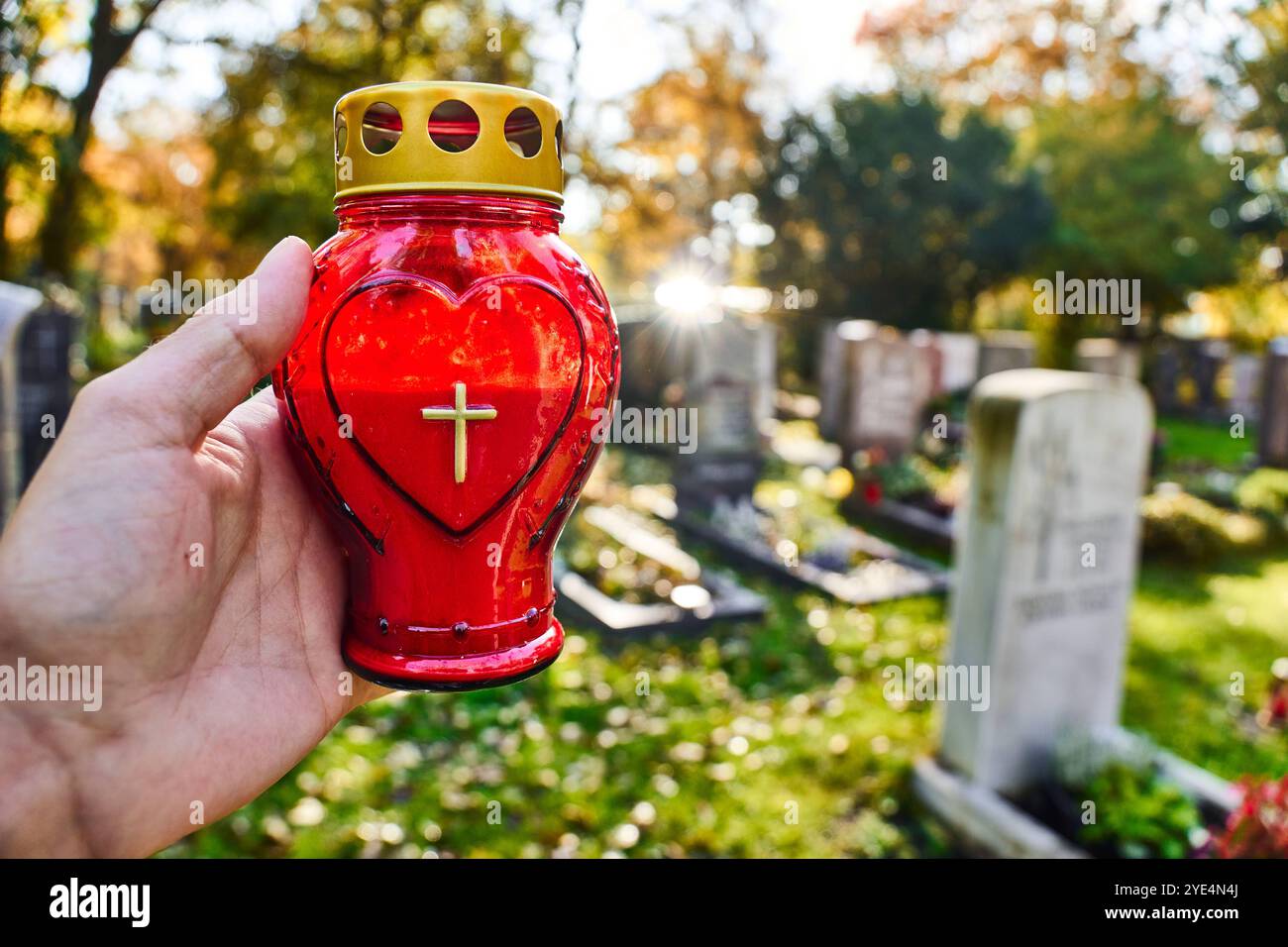 Bavaria, Germany - October 29, 2024: Hand holding a grave candle in ...