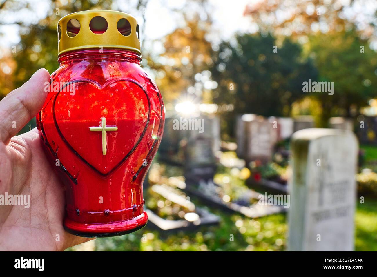 Bavaria, Germany - October 29, 2024: Hand holding a grave candle in ...