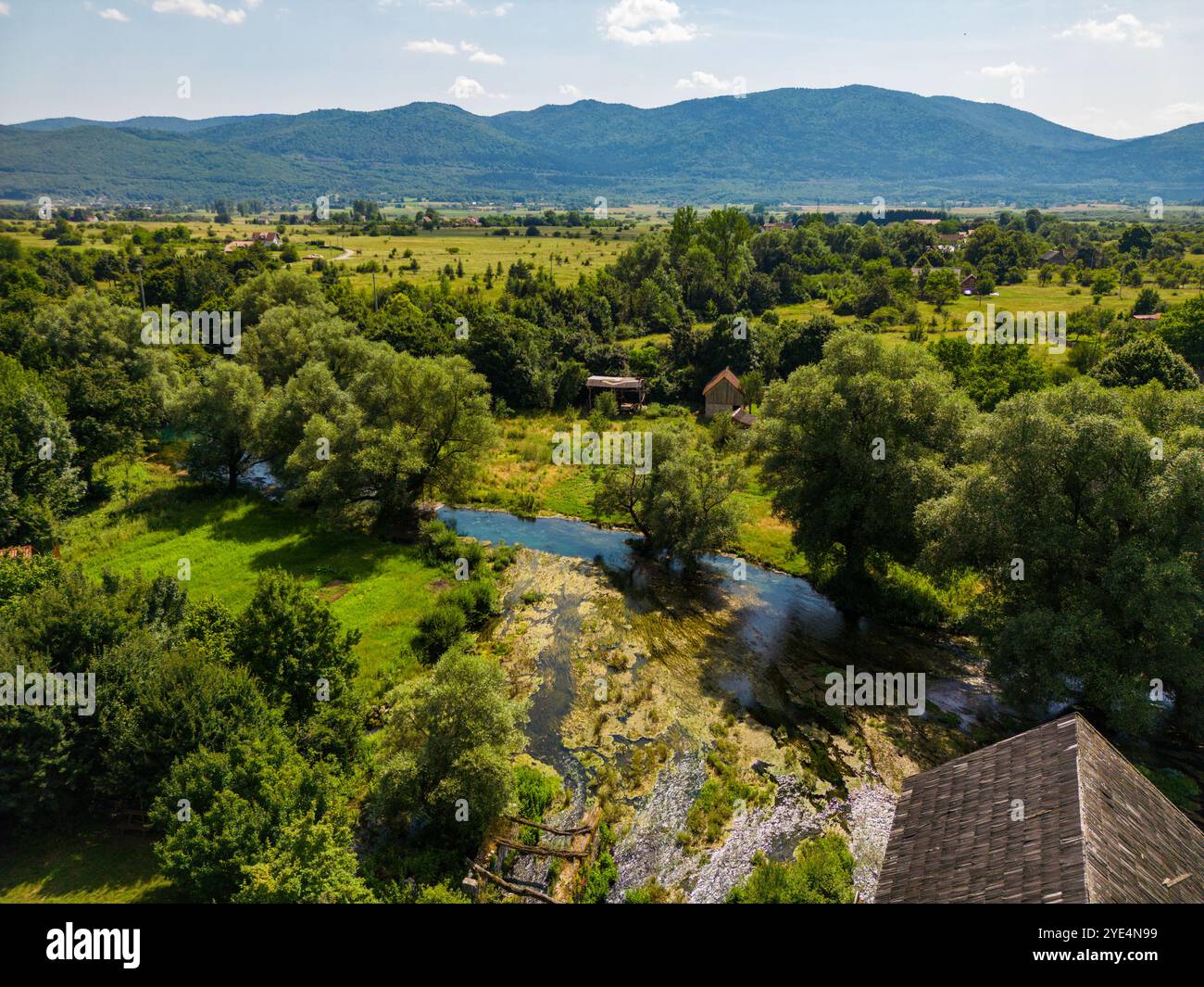 Aerial view of Gacka river valley, surrounded by mountains and forests ...