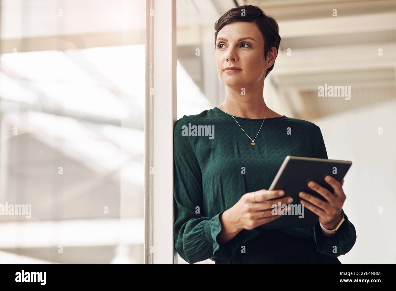 Woman, tablet and online thinking in office, brainstorming and ...