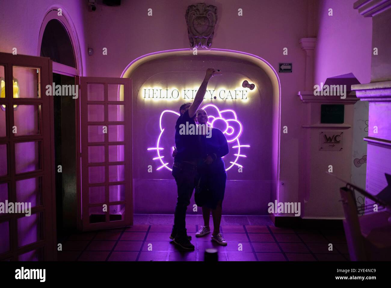 Fans of Japanese character Hello Kitty take photos in a Hello Kitty ...