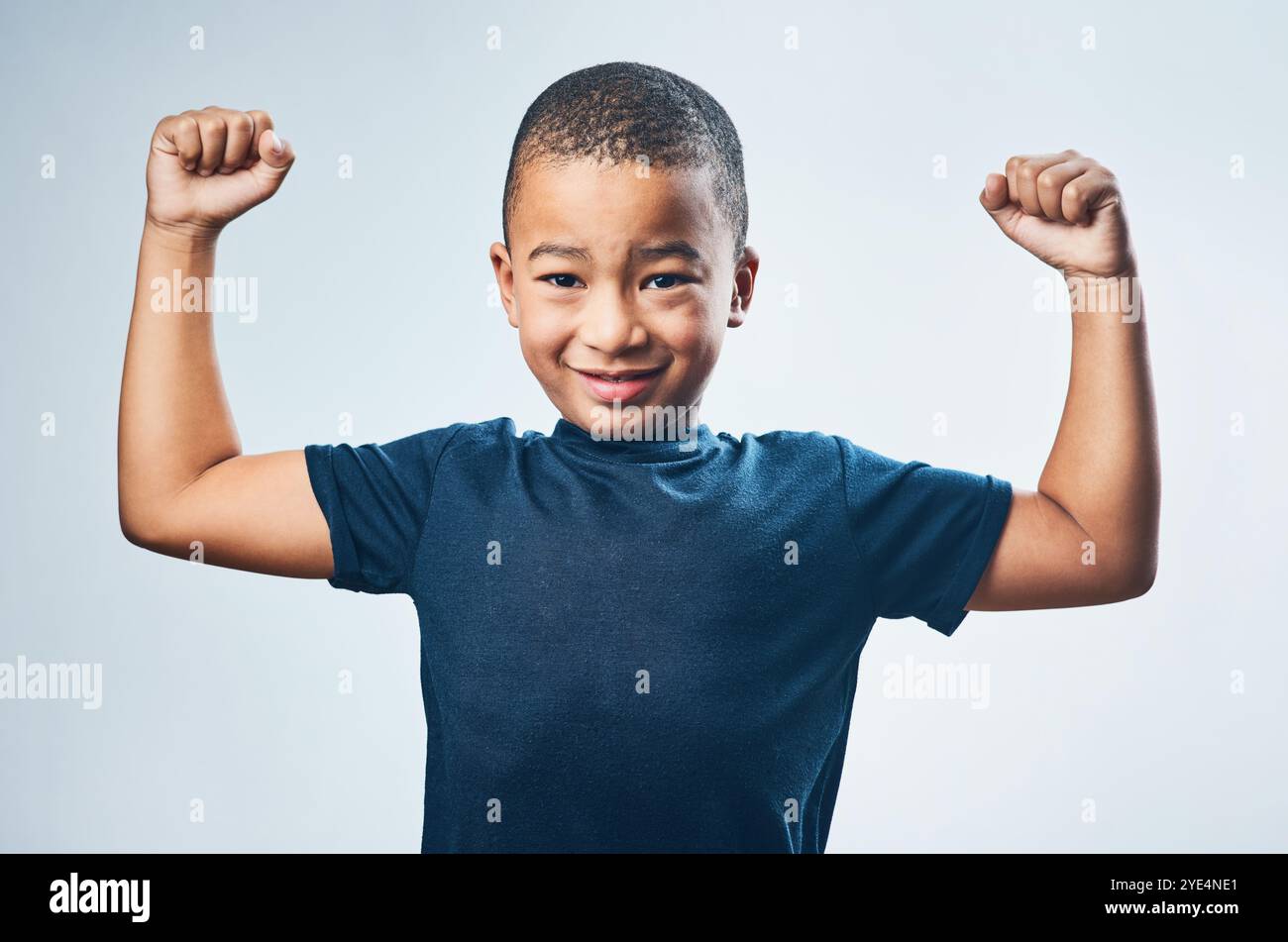 Portrait, boy and studio with flexing biceps for power, strength and ...