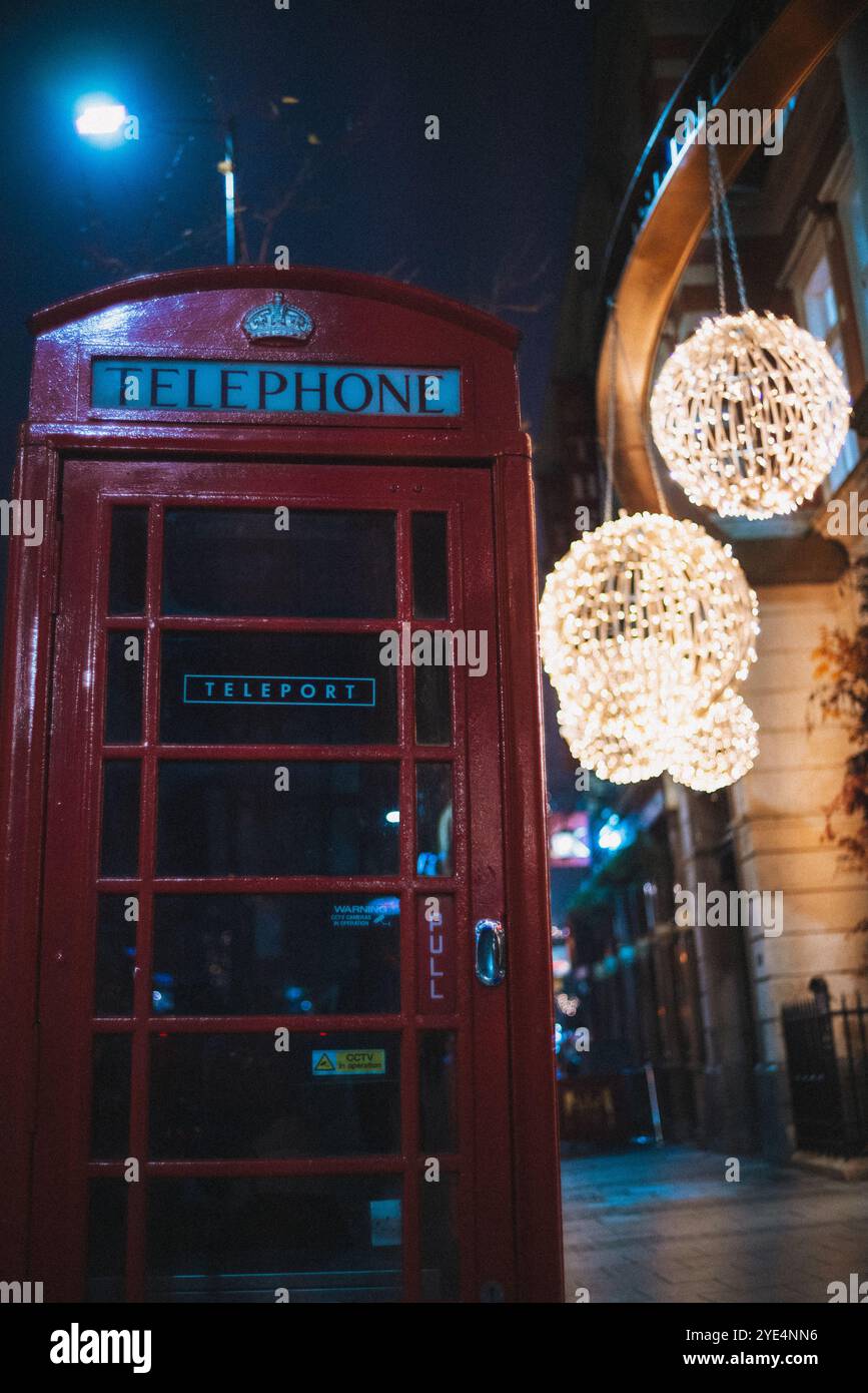 Iconic London red telephone booth at night with Christmas decorations ...