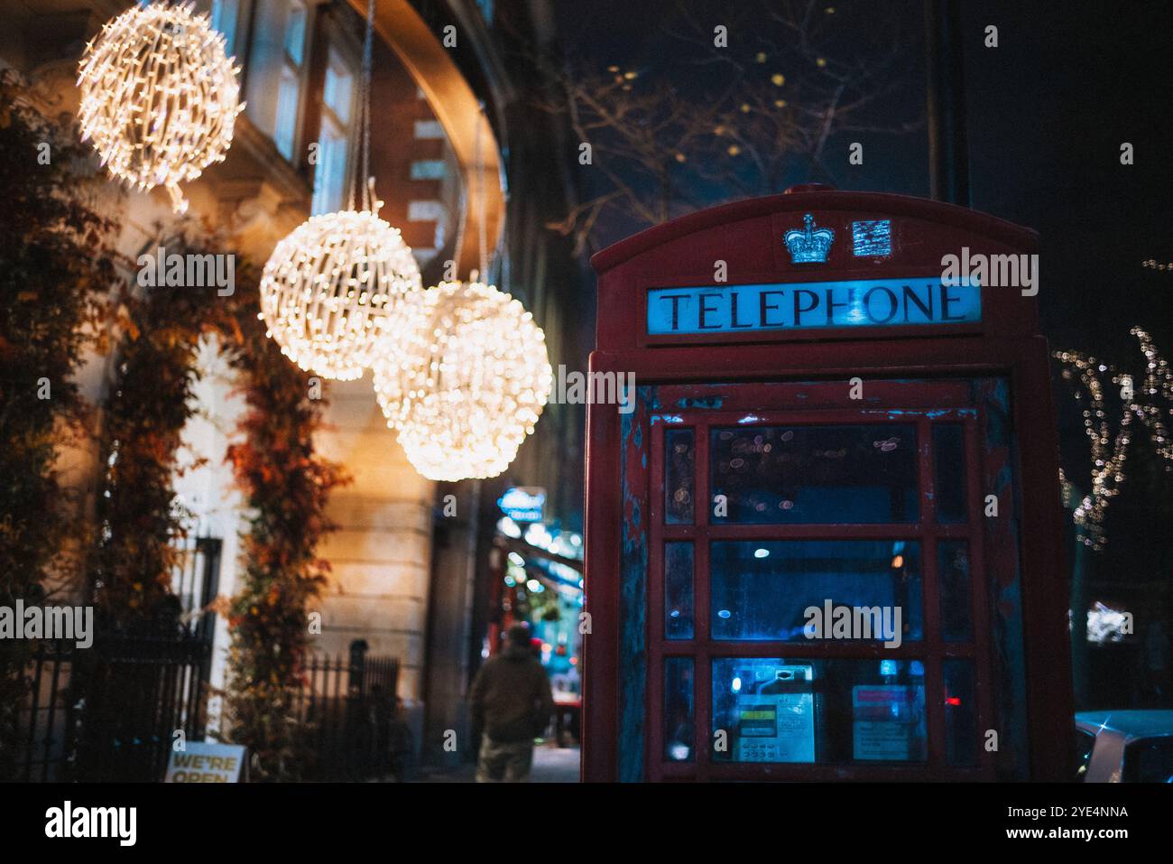 Iconic London red telephone booth at night with Christmas decorations ...