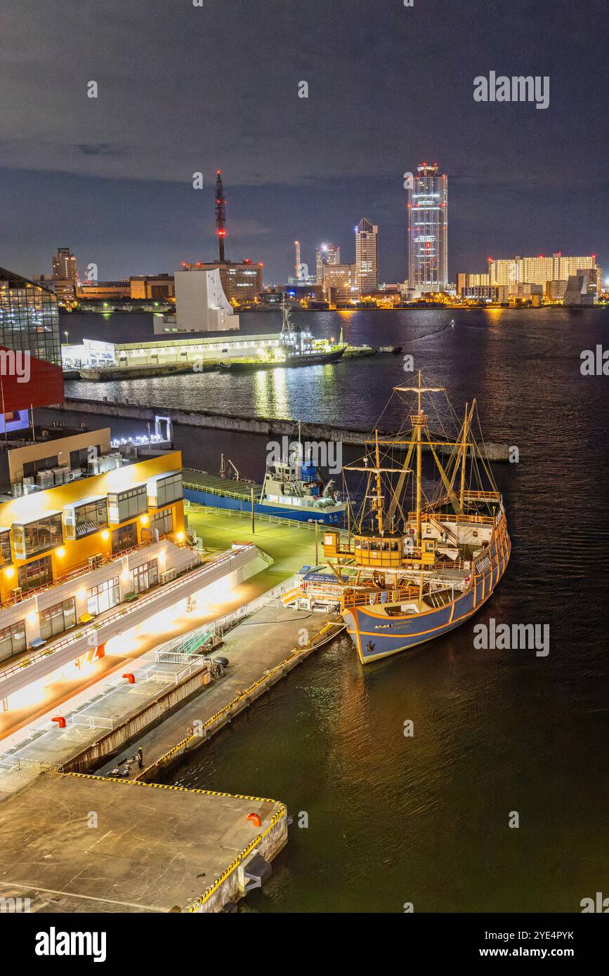 Nightscape of illuminated buildings including a replica Santa Maria ...