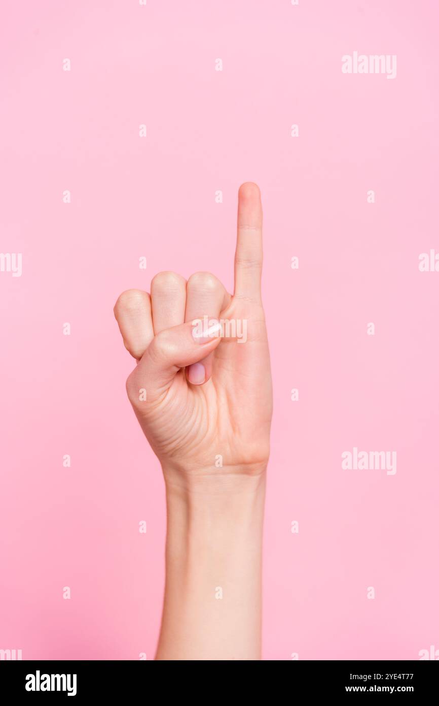 Vertical cropped view of attractive girl hand showing small little ...