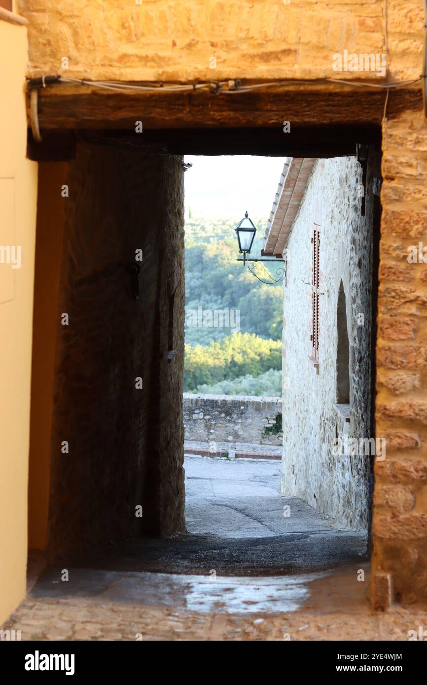View through an archway along a narrow back street in an old town Stock ...