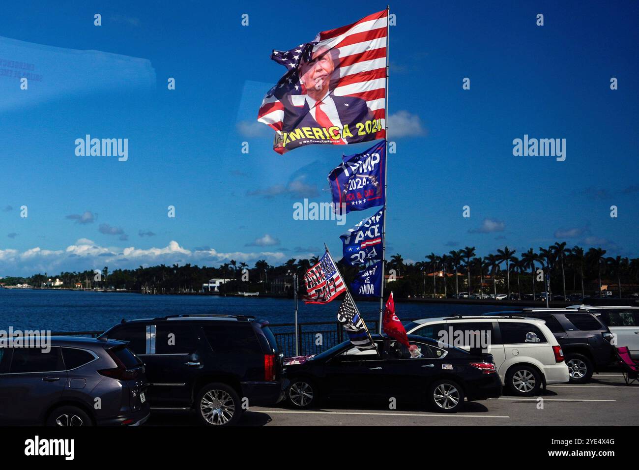 People watch the motorcade of Republican presidential nominee former ...