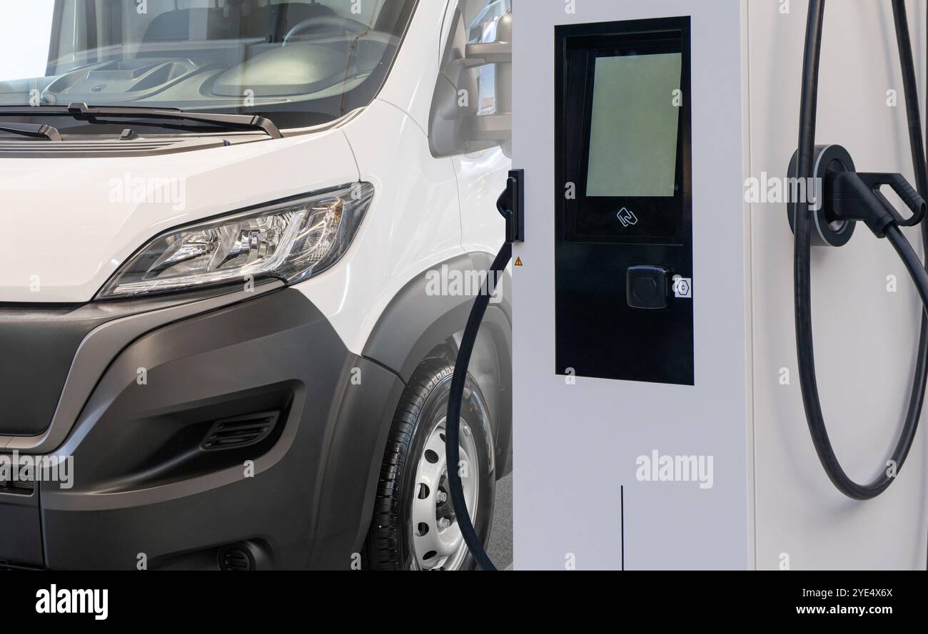 Electric delivery vans with electric vehicles charging station Stock ...