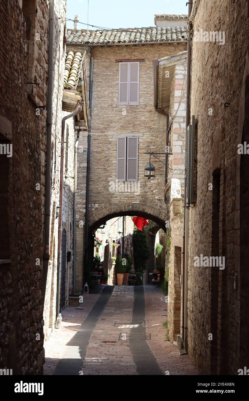 View along a narrow back street in an old town Stock Photo - Alamy