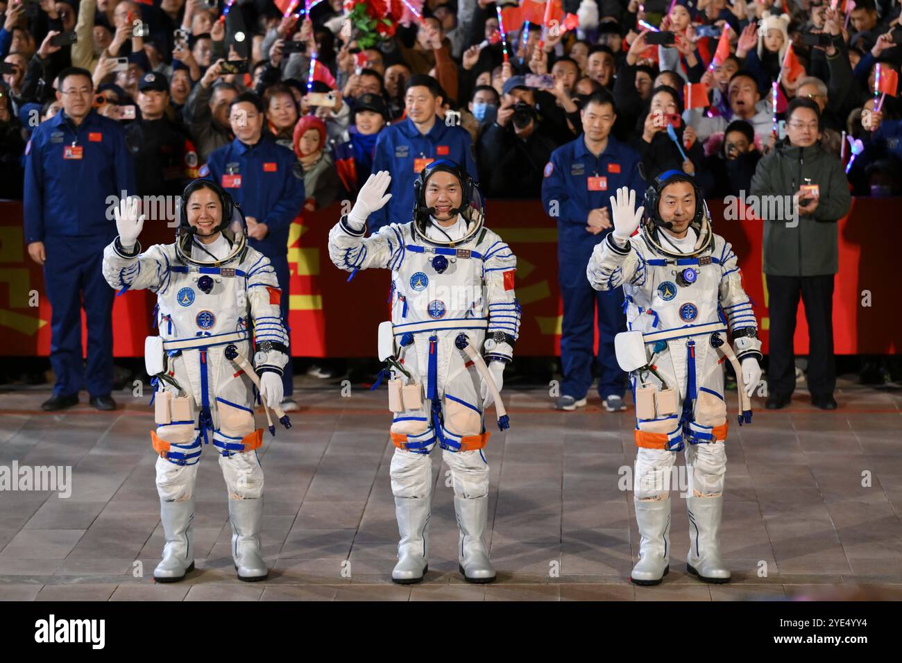 Jiuquan. 30th Oct, 2024. Chinese astronauts Cai Xuzhe (R), Song ...