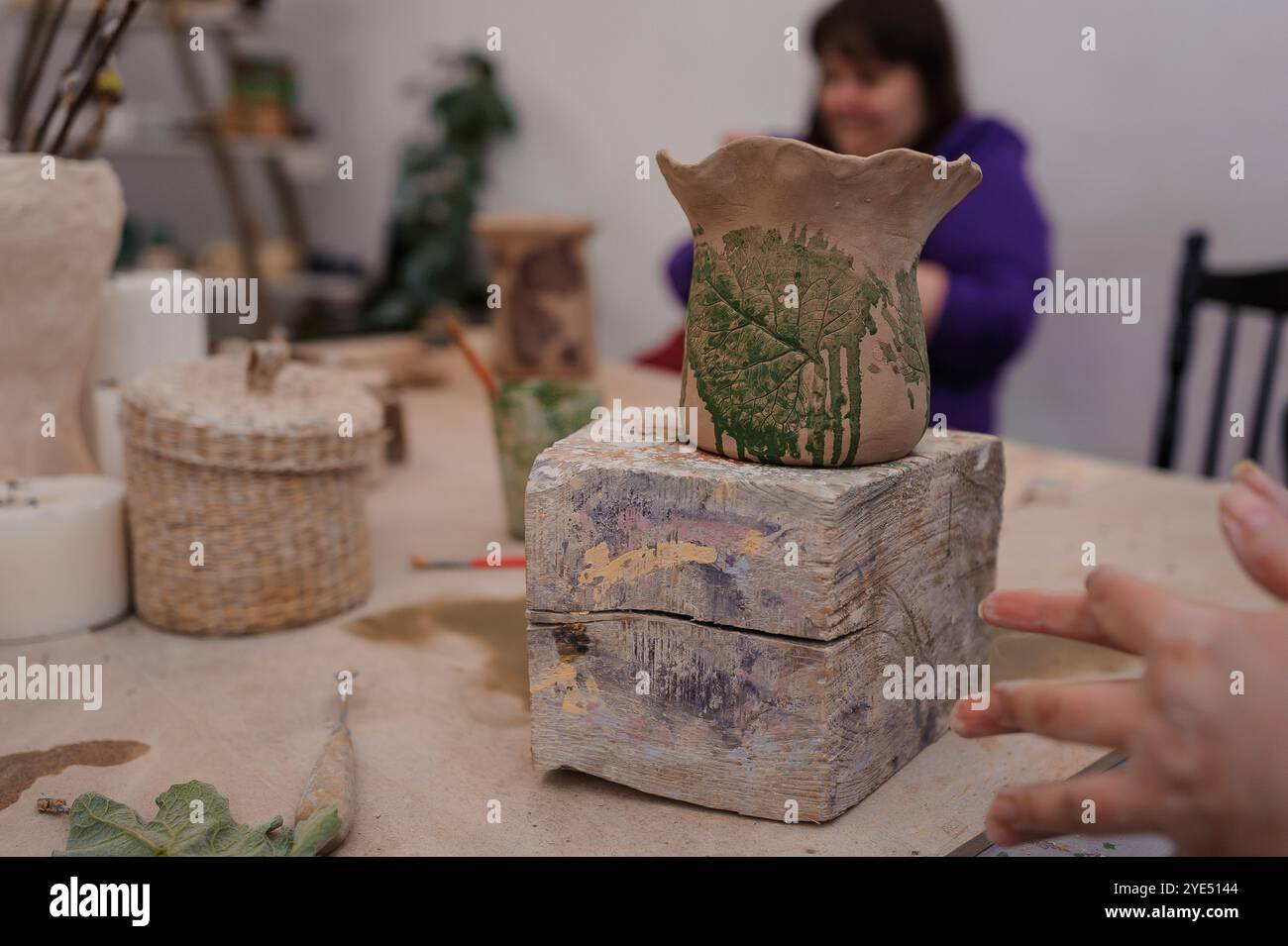 Artisan Pottery Creation with Leaf Imprint in a Creative Studio Setting ...