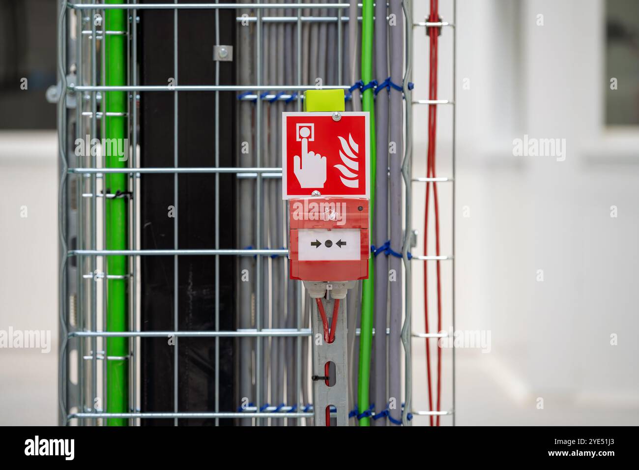 Manual call point and information sign on cable tray close up ...