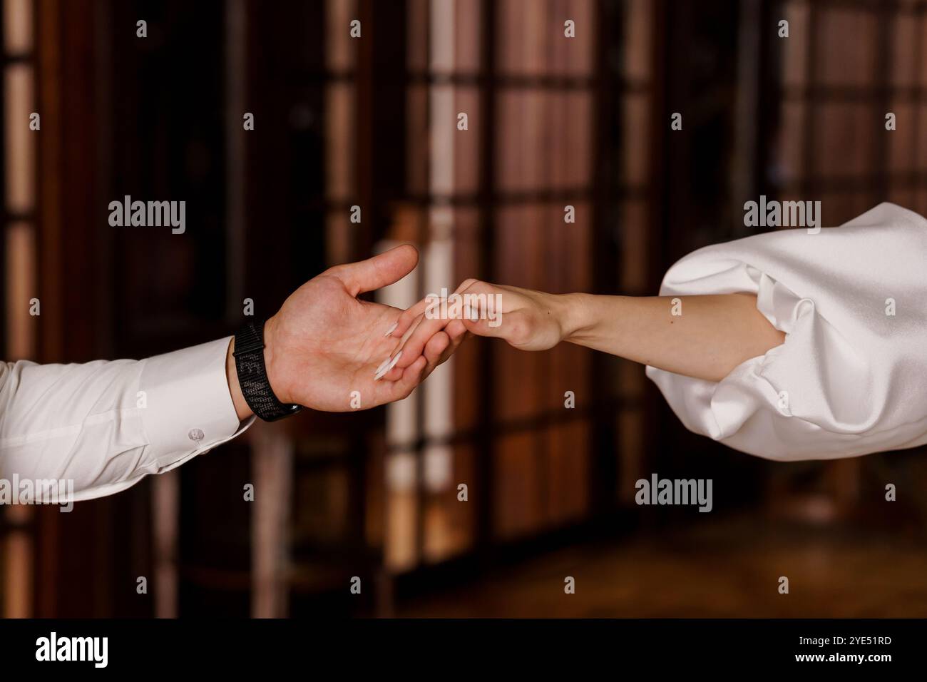 Elegant Connection: A Romantic Moment Between Two People Reaching for ...