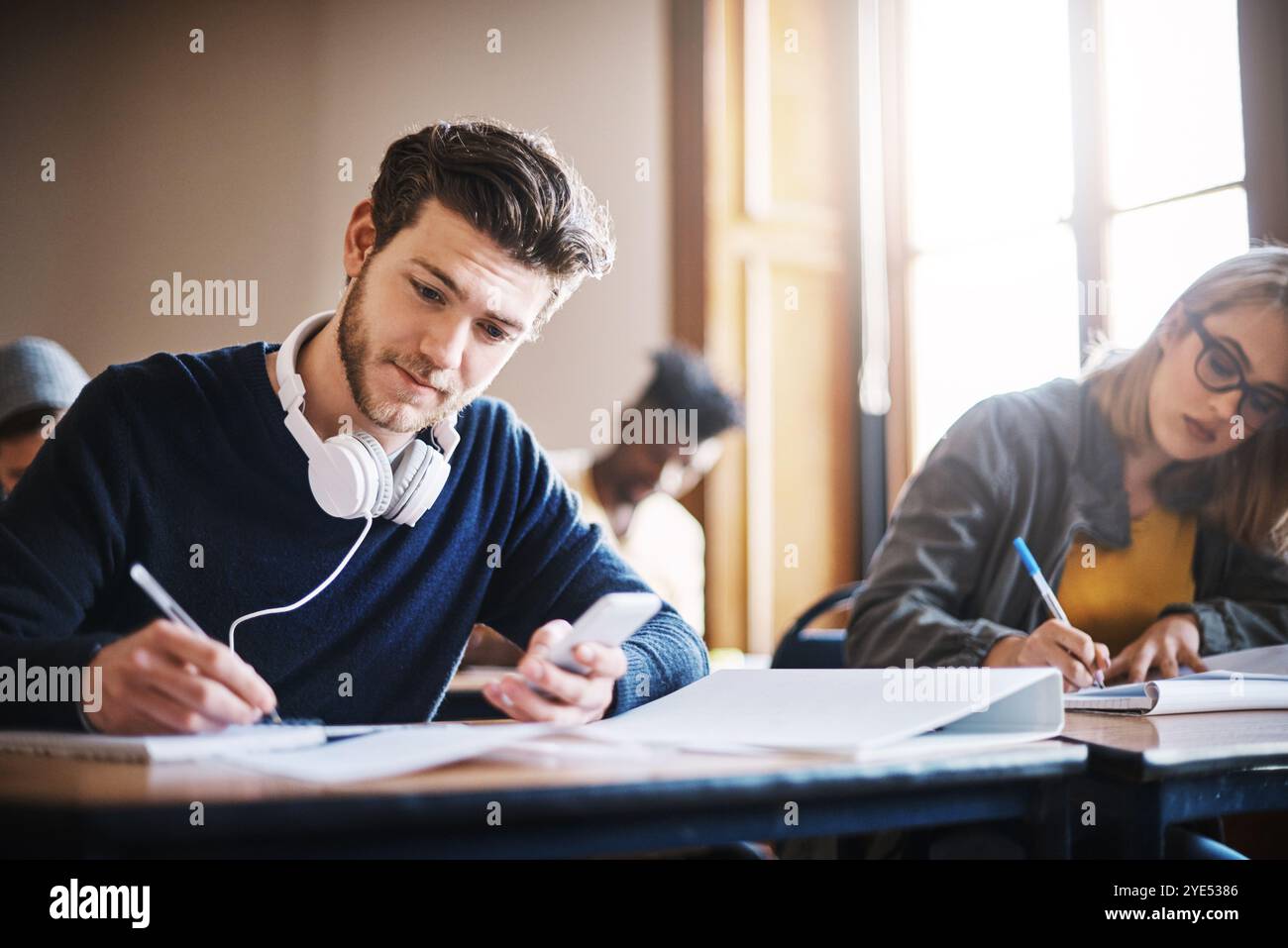 Writing, notebook and education with man in classroom for learning ...