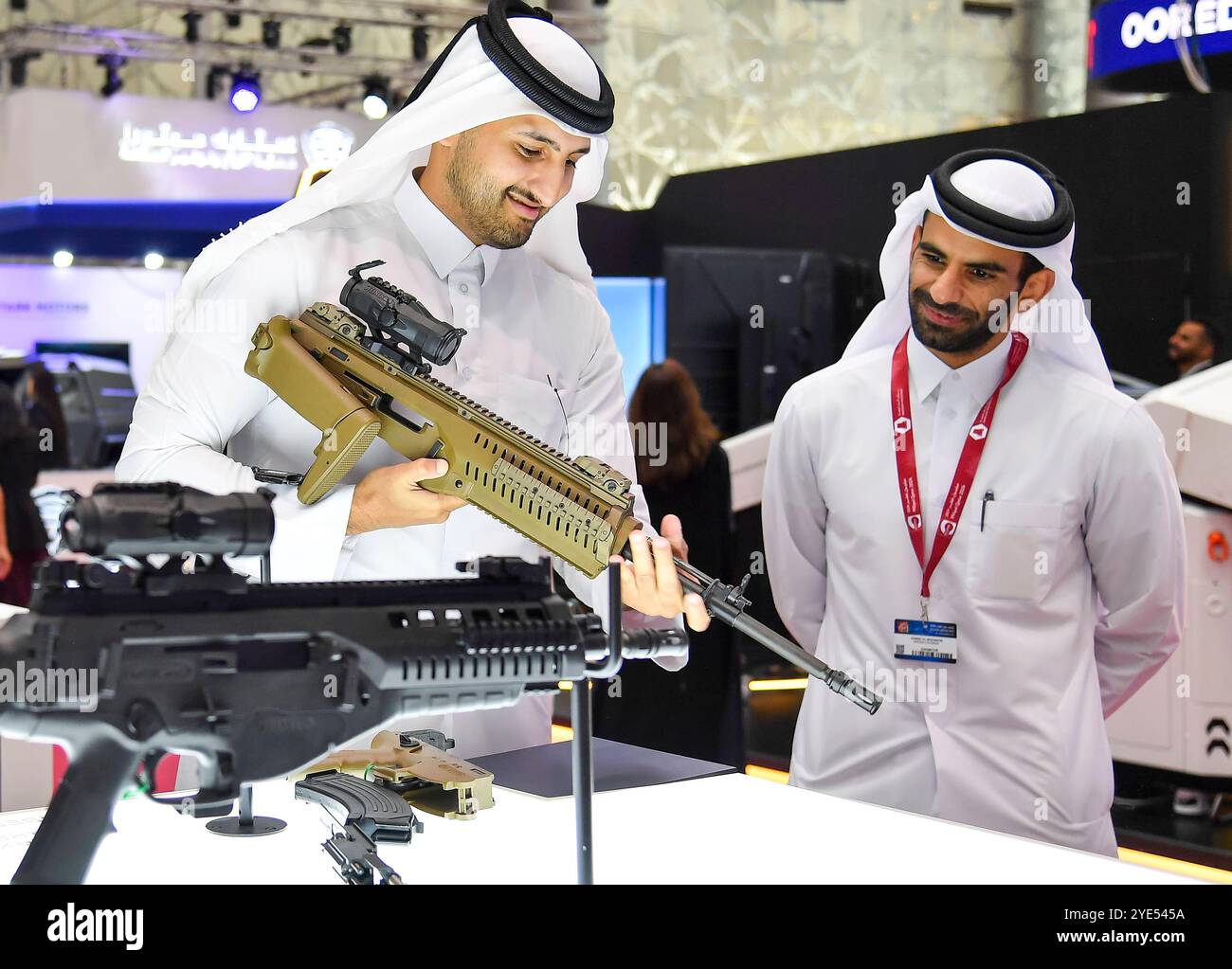 THE MILIPOL QATAR 2024 EXHIBITION IN QATAR A Qatari visitor looks at ...