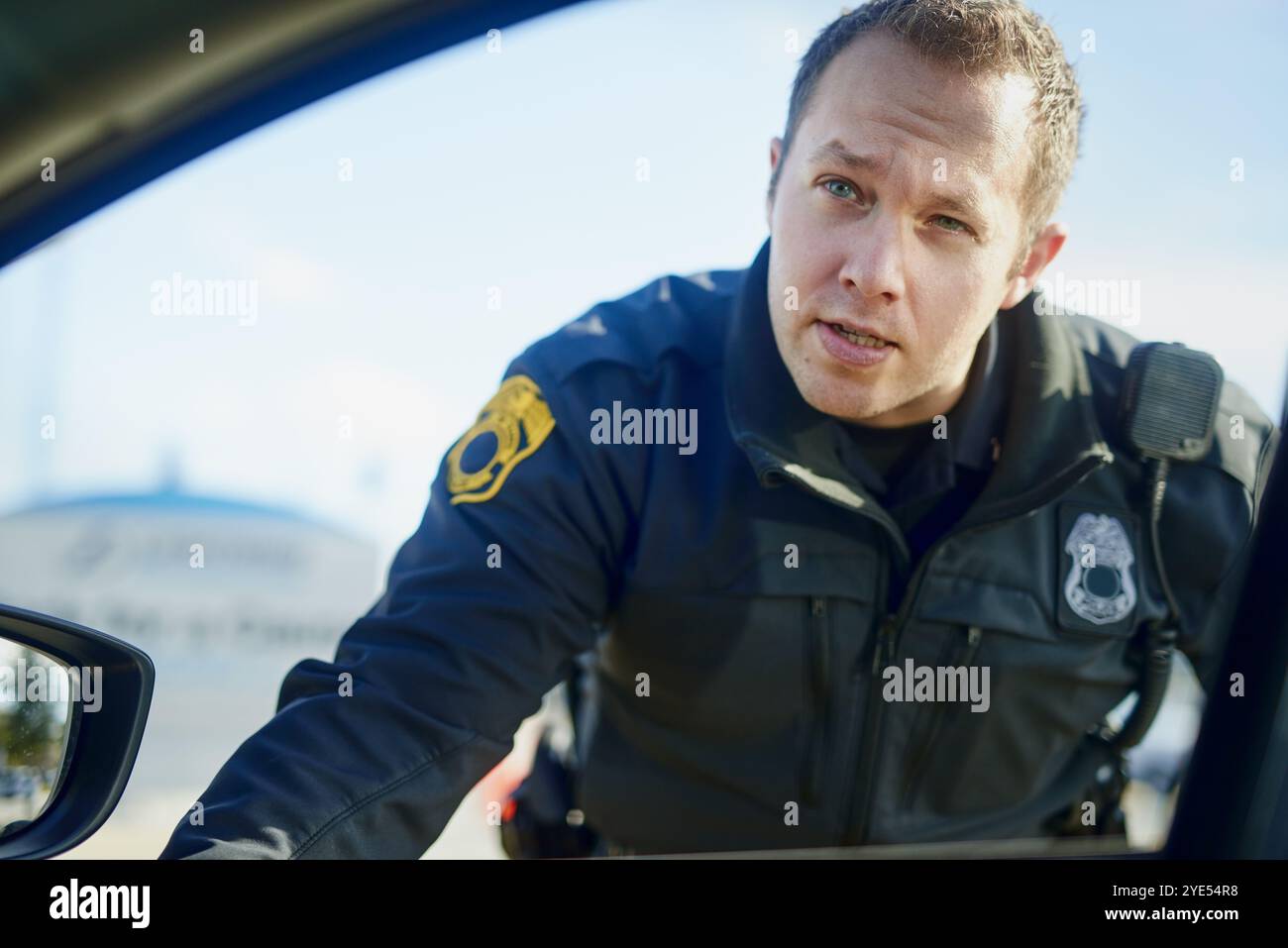 Traffic stop, police officer and talking at car for inspection, license ...