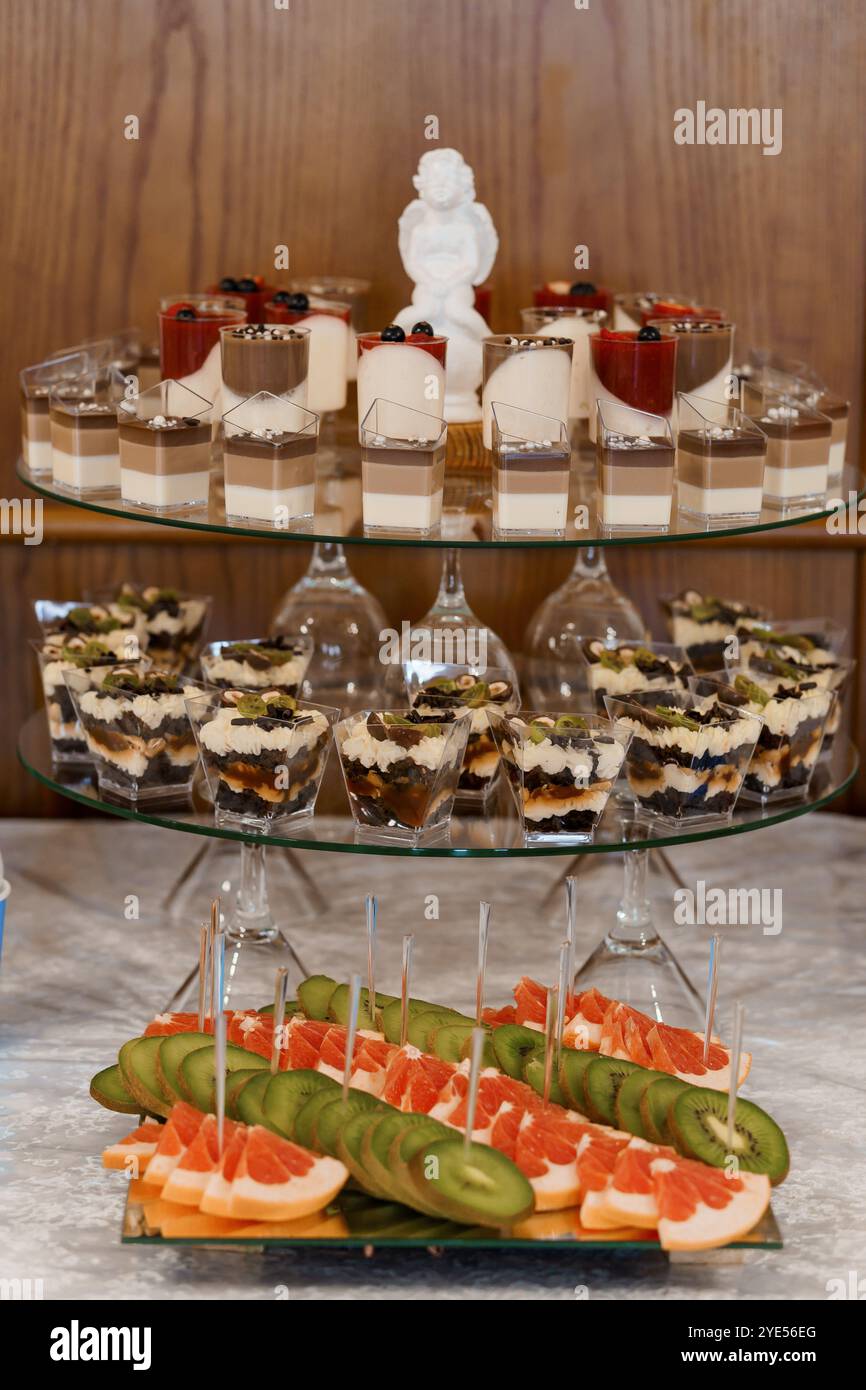 Elegant Dessert Display with Assorted Treats and Fruit Garnishes Stock Photo - Alamy