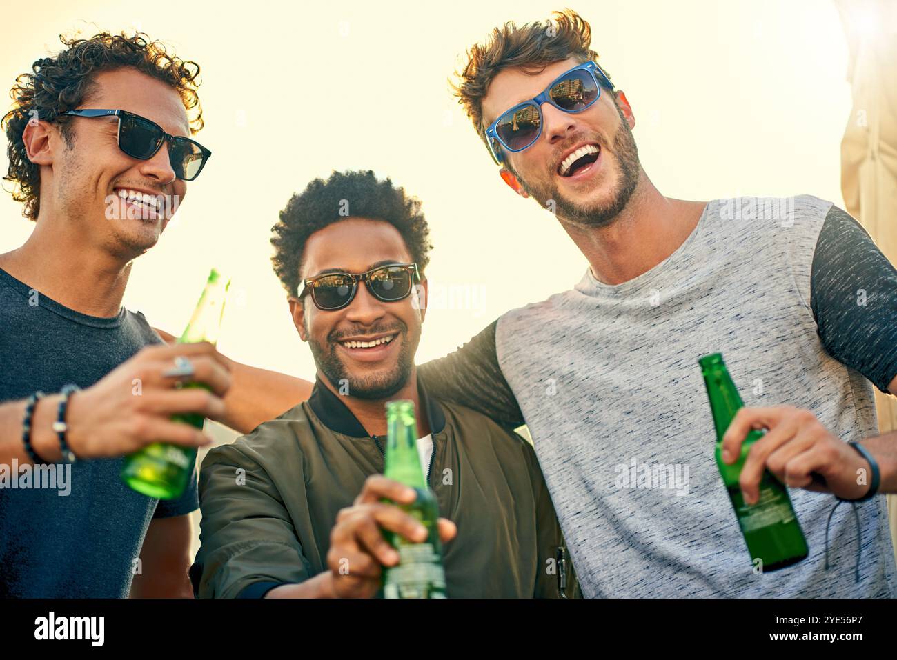 Friends, men and happy with alcohol, outdoor and celebration for ...