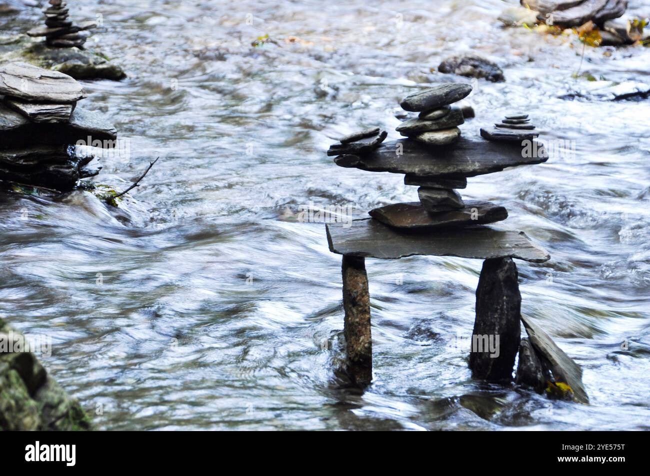 An interesting arrangement of stones balanced in the stream below the ...