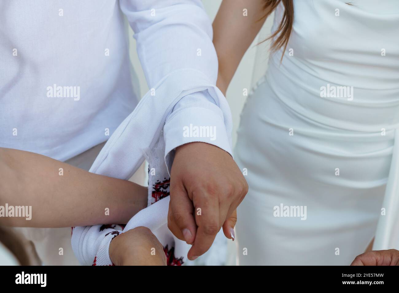 Bonding Ties: Symbolic Unity in a Wedding Ceremony Stock Photo - Alamy