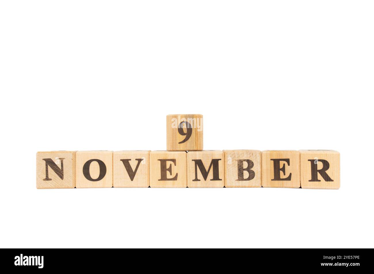 November 9, Wooden cube on isolated white background. Book, Colleen Hoover, opening of the ...